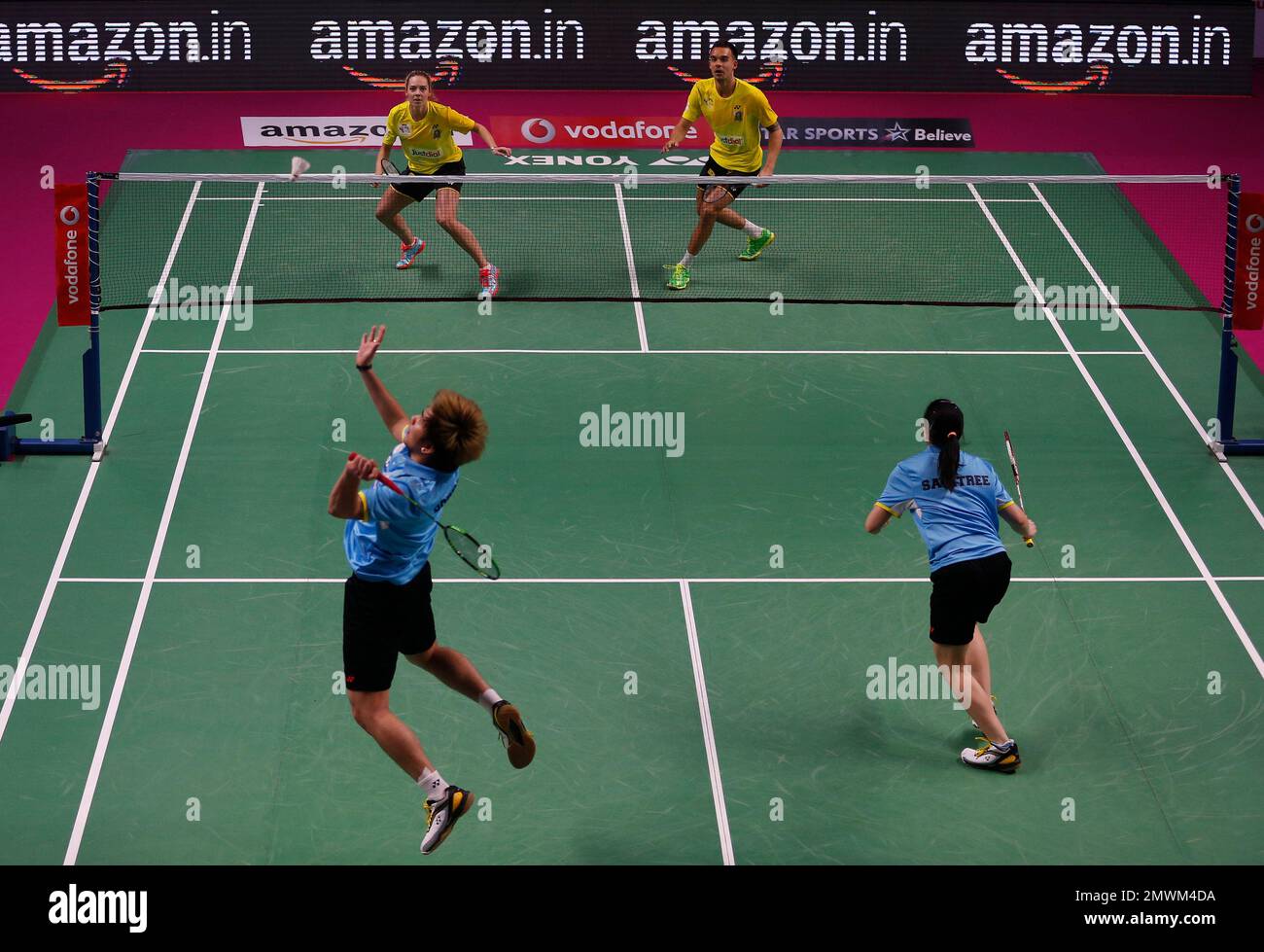 Thai badminton player Bodin Isara plays a shot with compatriot Savitree ...