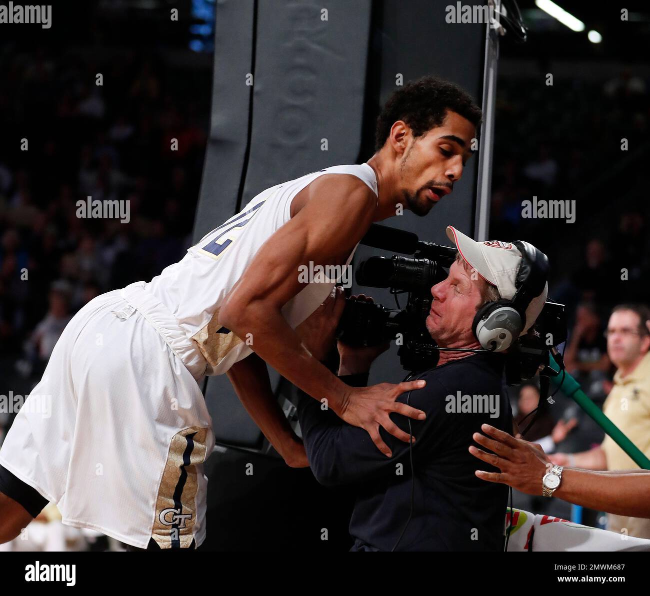 Georgia Tech forward Quinton Stephens (12) crashes into a television ...