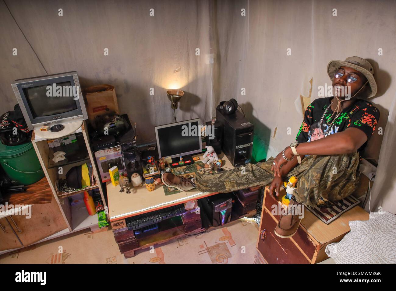22-Year-Old Brian Thomas dressed in his nice attire poses inside his ...