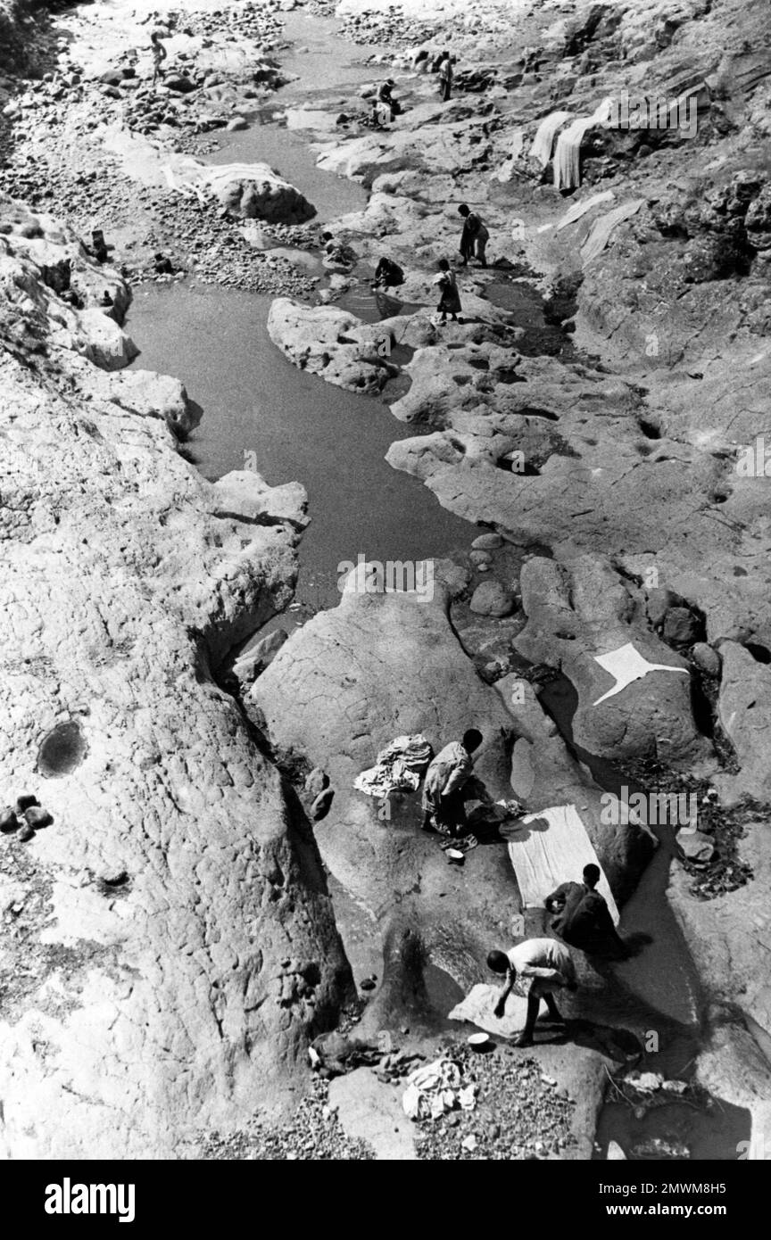 Native women making the most of a meagre supply of water in a creek on ...