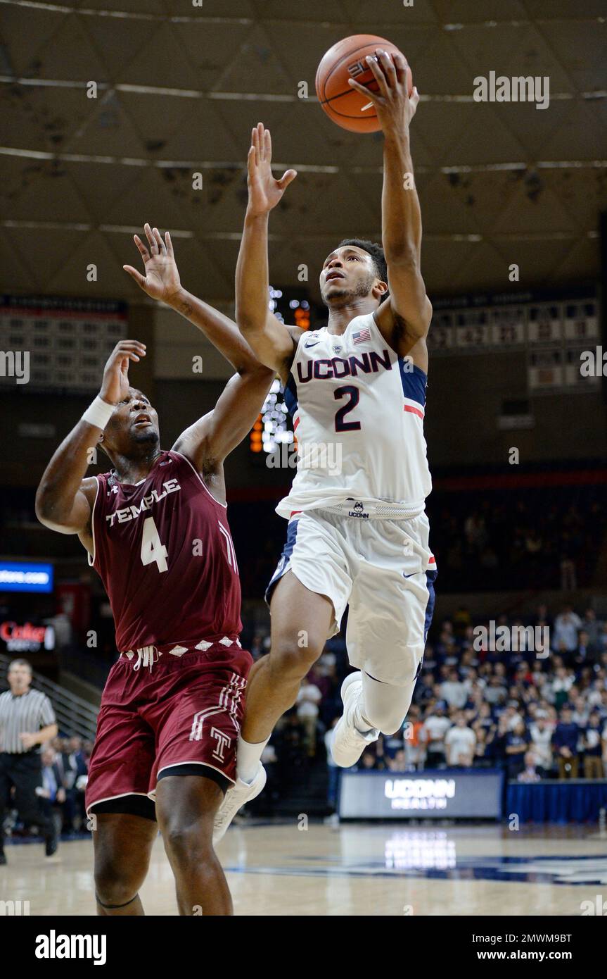Connecticut’s Jalen Adams goes up for a basket over Temple’s Daniel ...