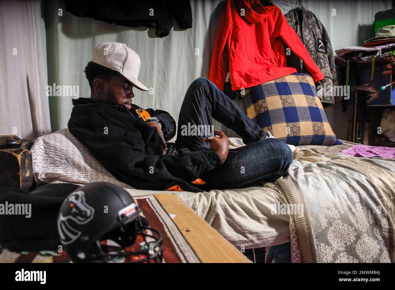 22-Year-Old Brian Thomas dressed in his nice attire poses inside his ...