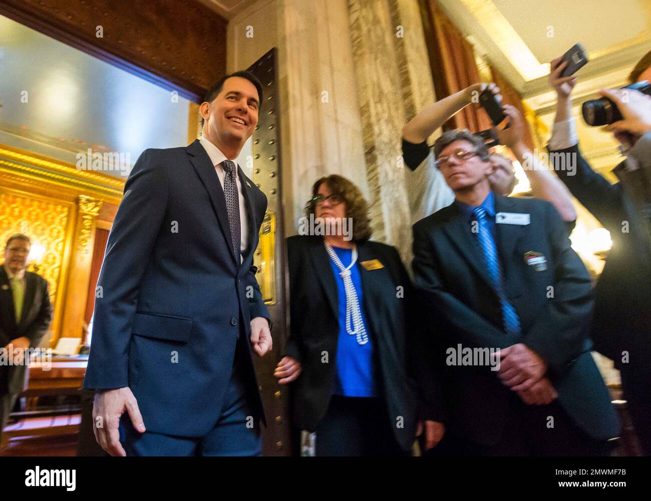 Wisconsin Gov. Scott Walker enters the assembly chambers to give his ...