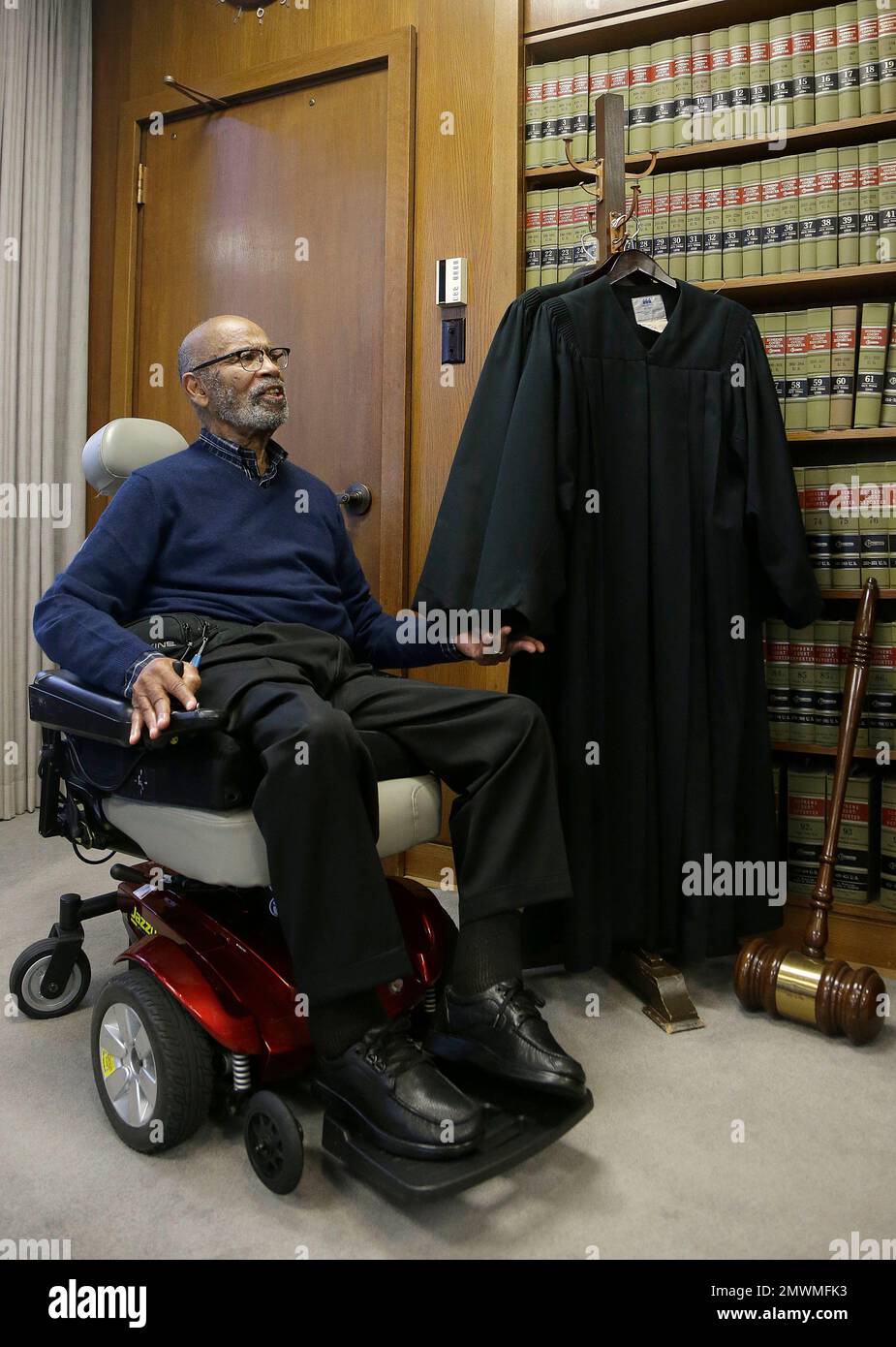 U.S. District Court Judge Thelton Henderson sits next to his robe while ...