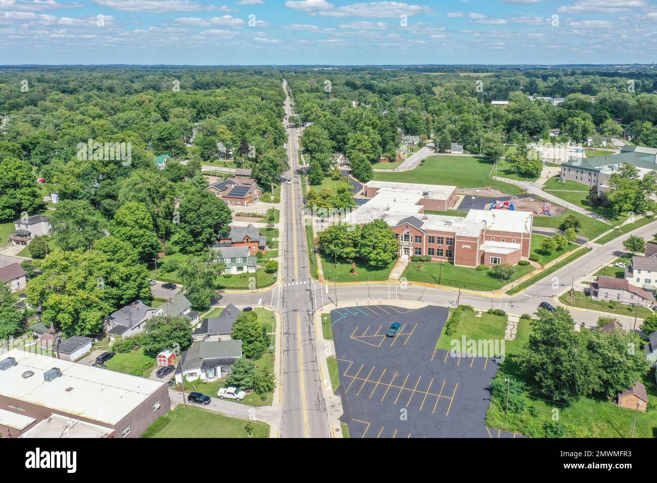 An aerial view of a multiple lane highway road with green vegetation ...