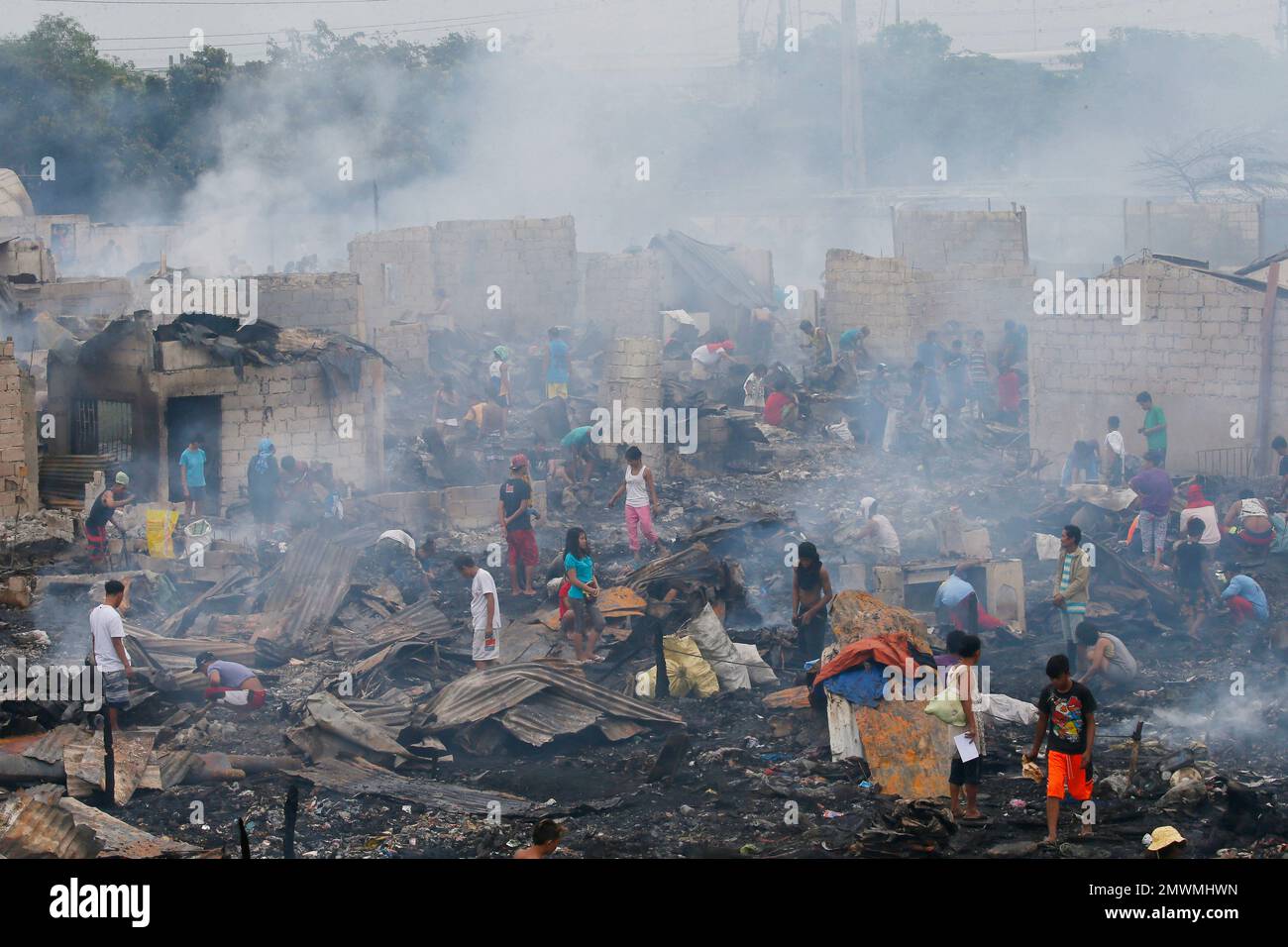 Residents of a community in suburban Navotas sift through the ...