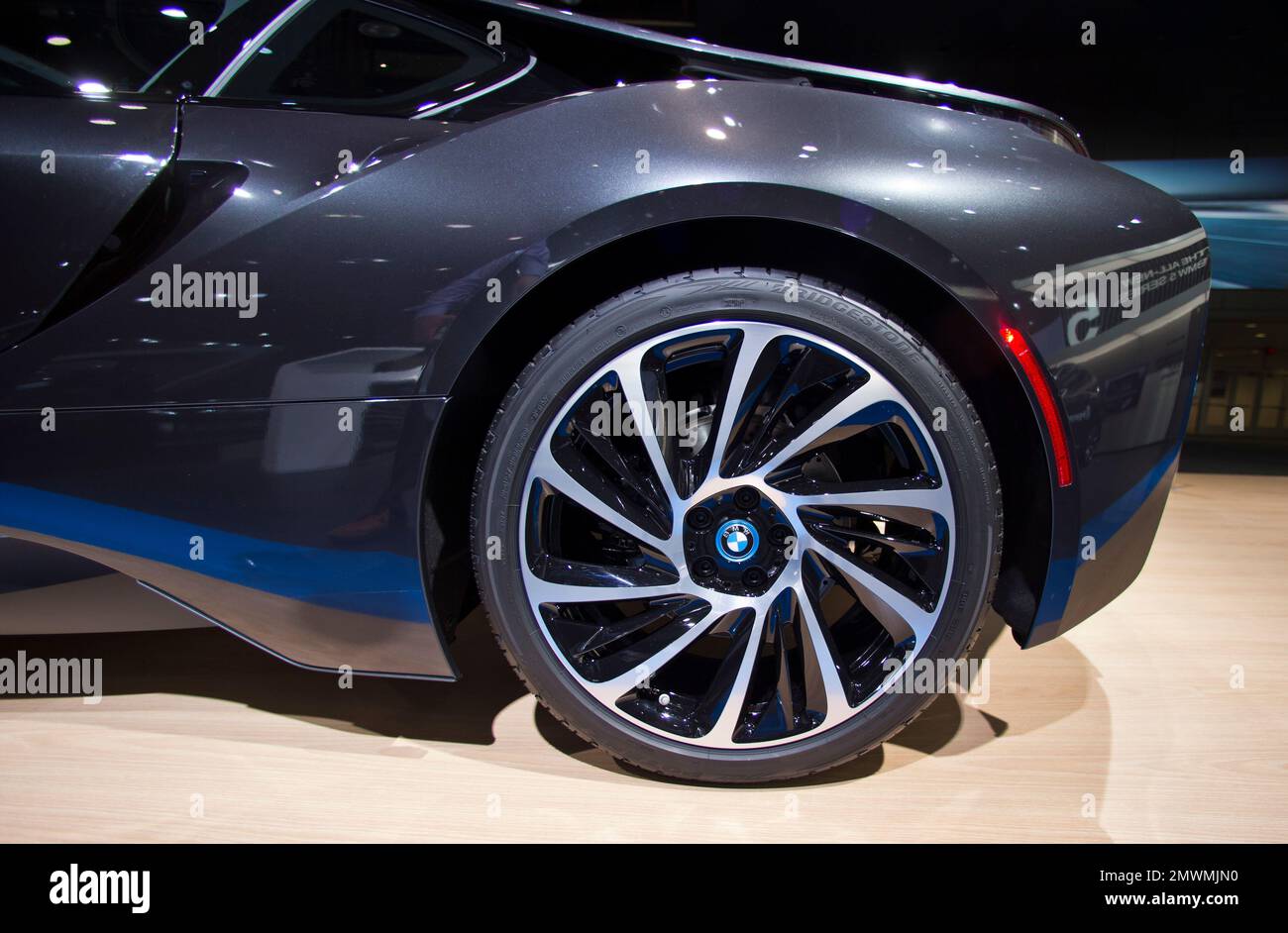 A driver's side rear wheel side view of a BMW i8 plug-in hybrid sports ...