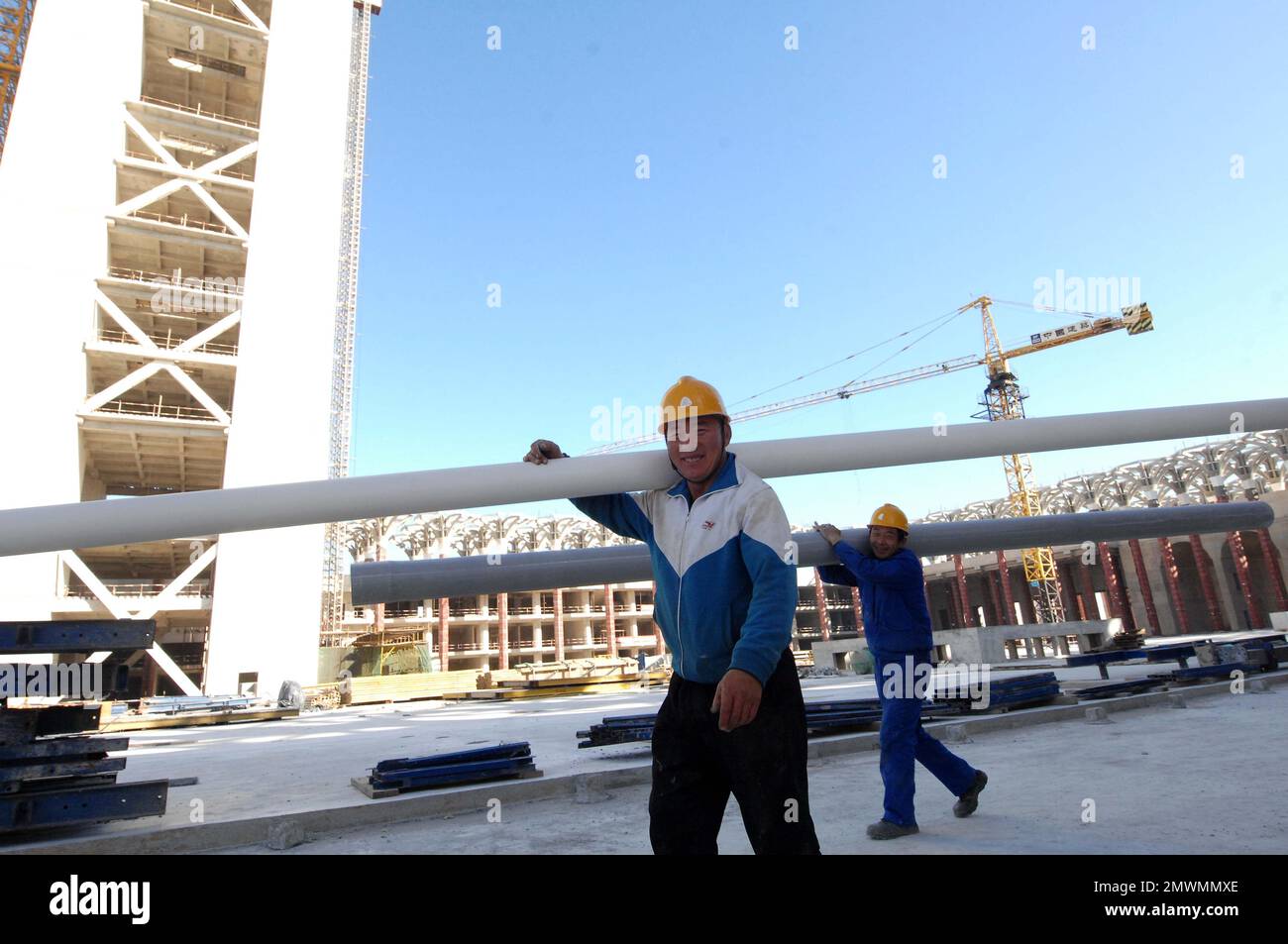 A worker carries a pipe at the Grand Mosque of Algiers under ...