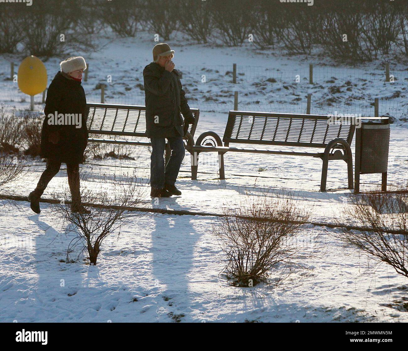 People walk in the snow covered park Kepa Potocka in Warsaw, Poland ...