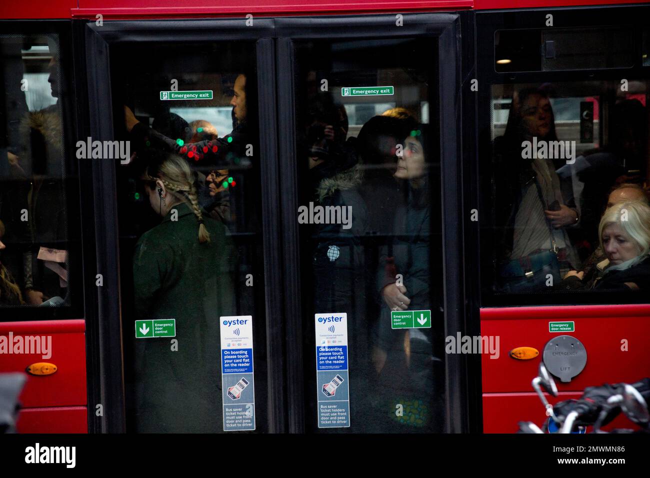 During the morning rush hour, people stand on a crowded bus in London ...