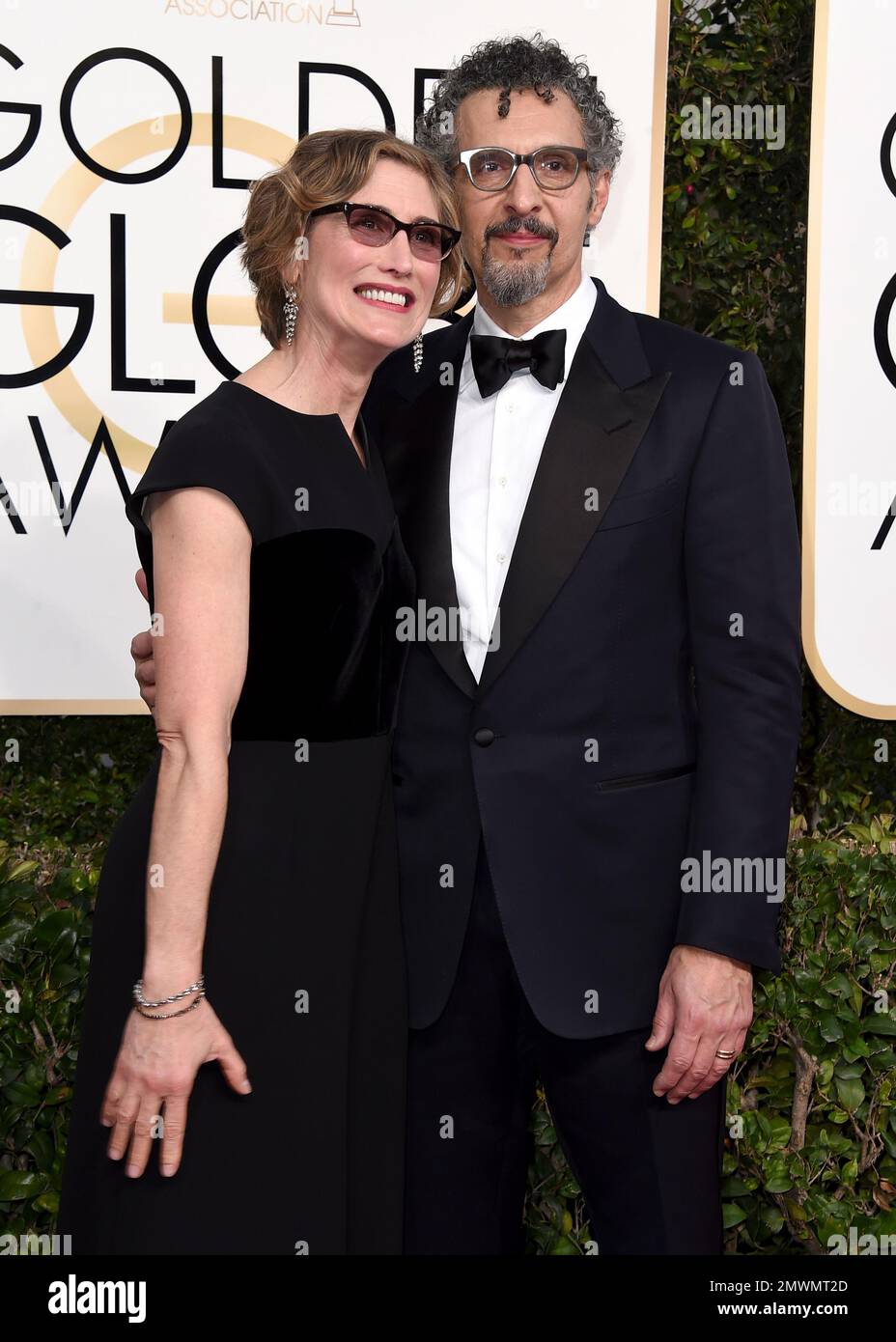 Katherine Borowitz, left, and John Turturro arrive at the 74th annual Golden Globe Awards at the ...