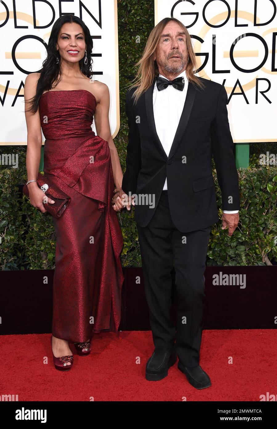Nina Alu, left, and Iggy Pop arrive at the 74th annual Golden Globe ...