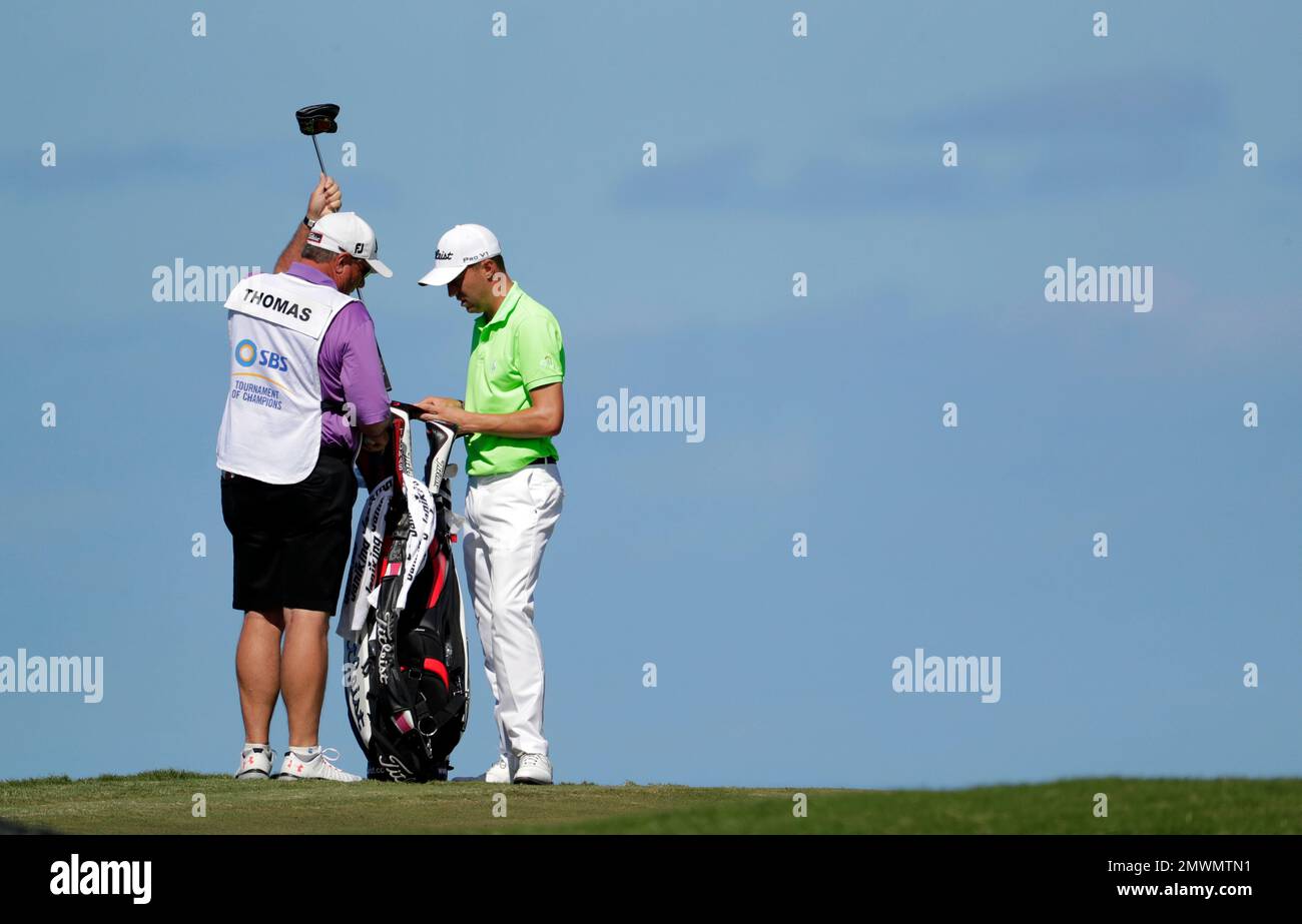 Justin Thomas talks with his caddy on the 12th green during the final ...
