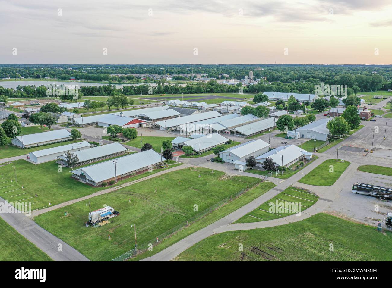 An aerial view of a small industrial complex with green vegetation at ...