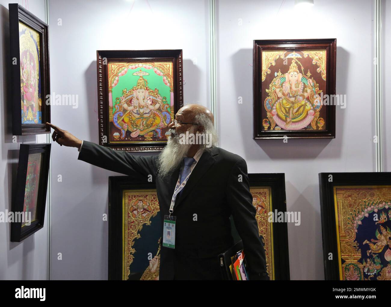 A delegate checks out traditional Indian art works at a stall at the ...