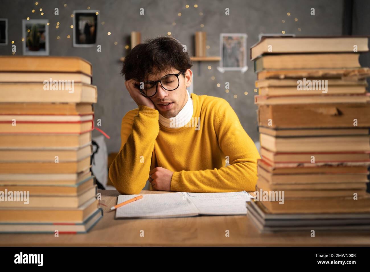 Student reading books preparing for exams, tired young man sleeping at ...