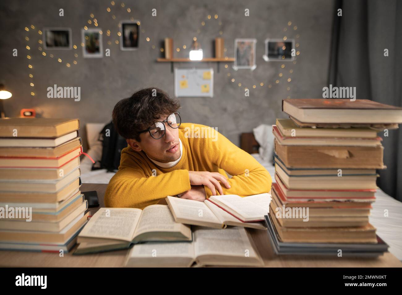 Student studying hard exam and sleeping at table between books in ...