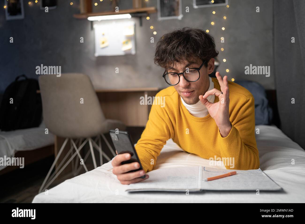 Student communicating via video call showing fingers ok sign to his ...