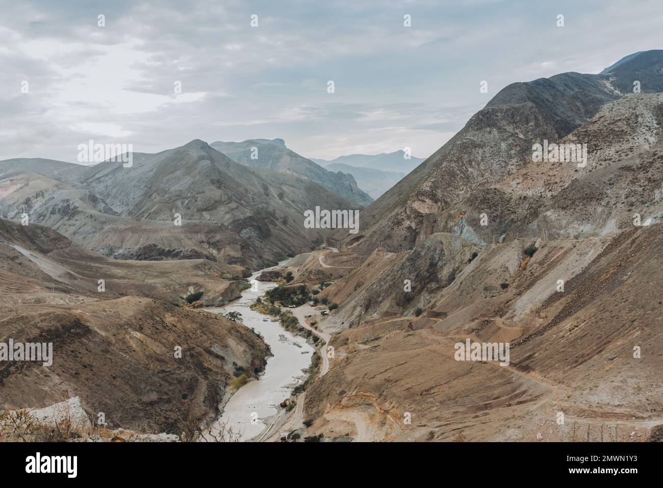The view of a river flowing between mountains Stock Photo - Alamy