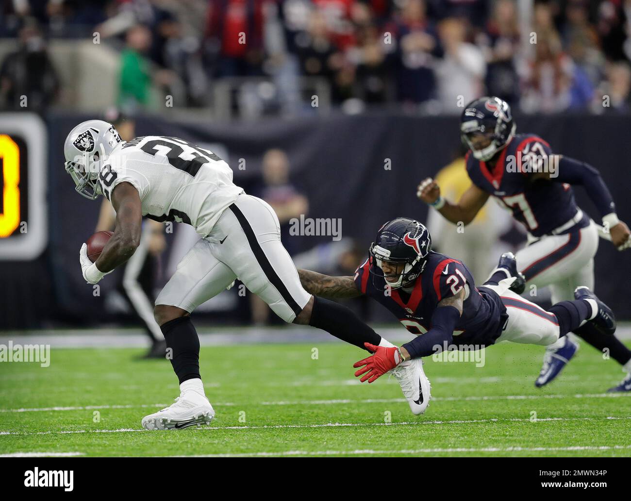 Oakland Raiders running back Latavius Murray (28) is tripped up by ...