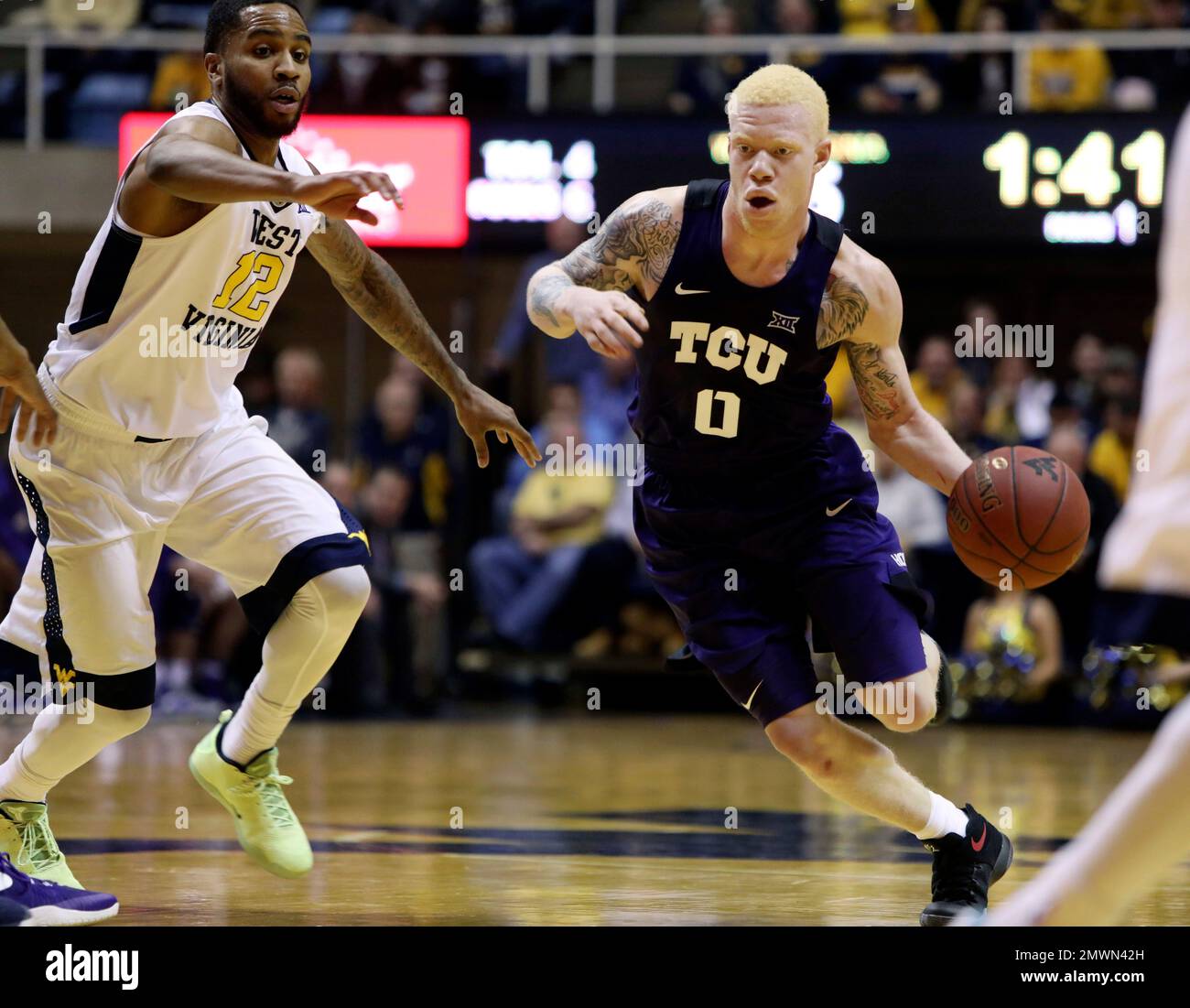 TCU guard Jaylen Fisher (0) drives to the basket as West Virginia guard ...