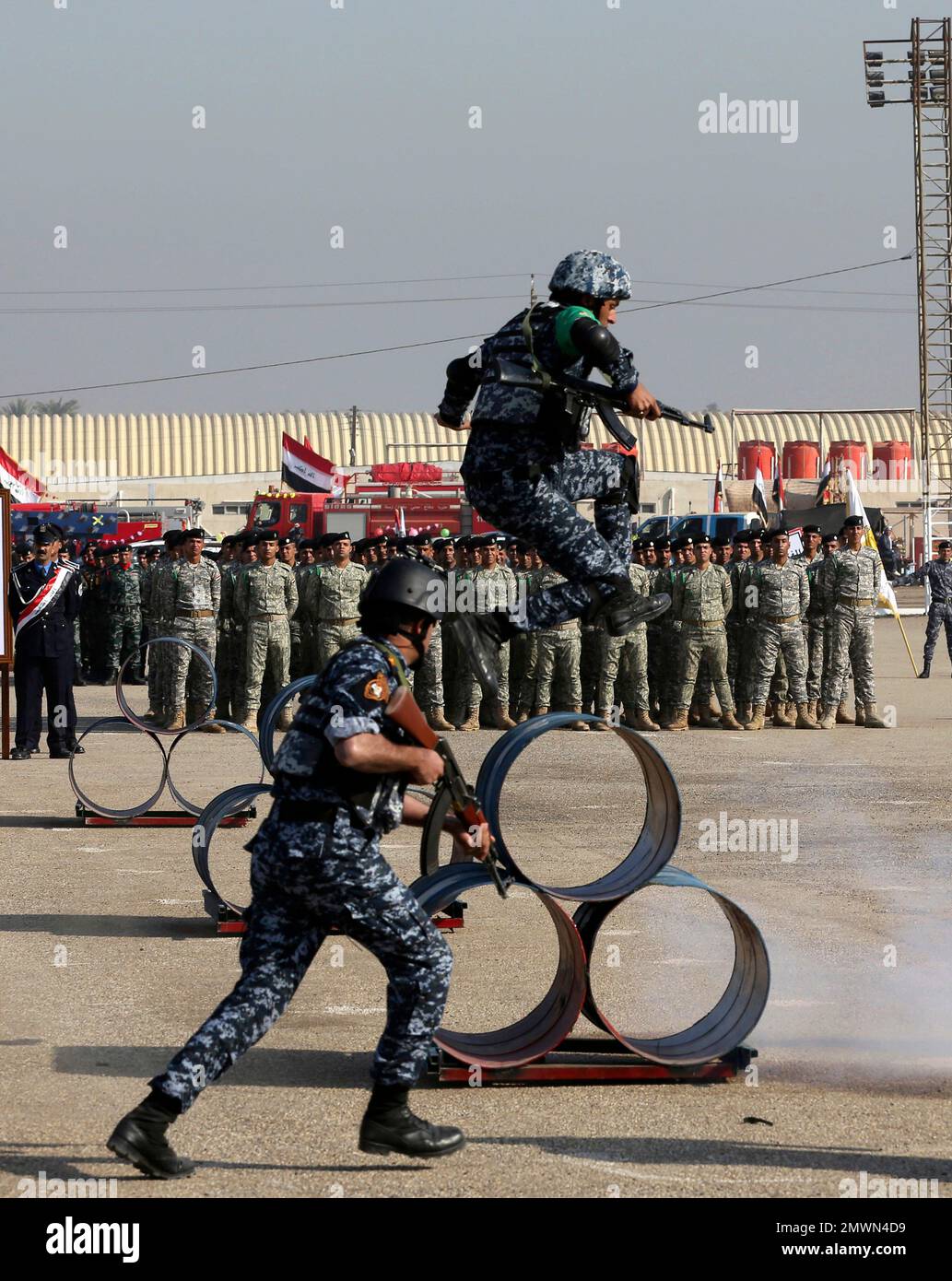 Iraqi Federal Police demonstrate their skills during a ceremony marking ...