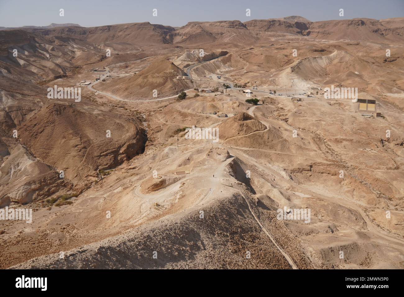 An aerial view of Masada with ancient fortress and rocky cliffs in ...