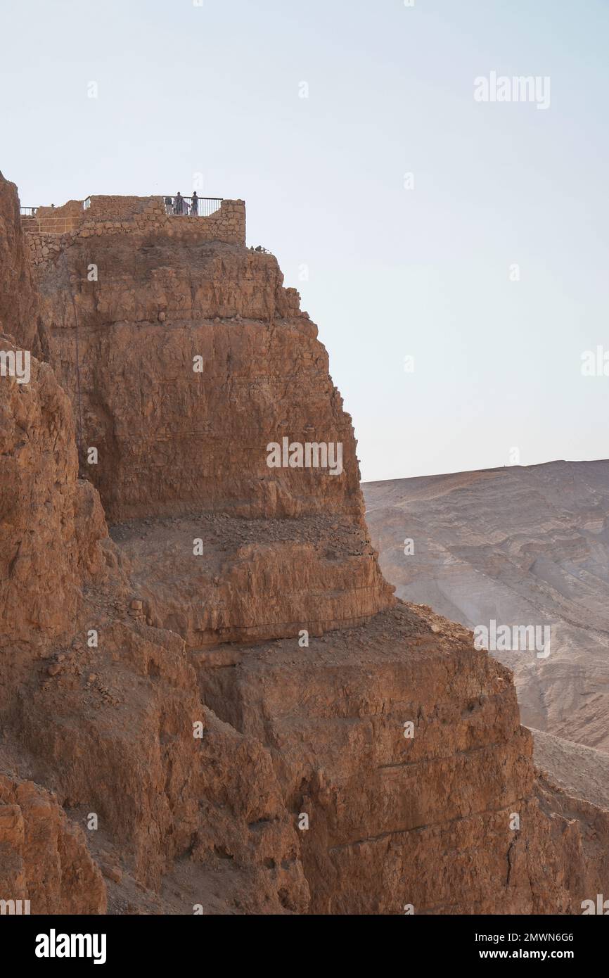 An aerial view of Masada with ancient fortress and rocky cliffs in ...