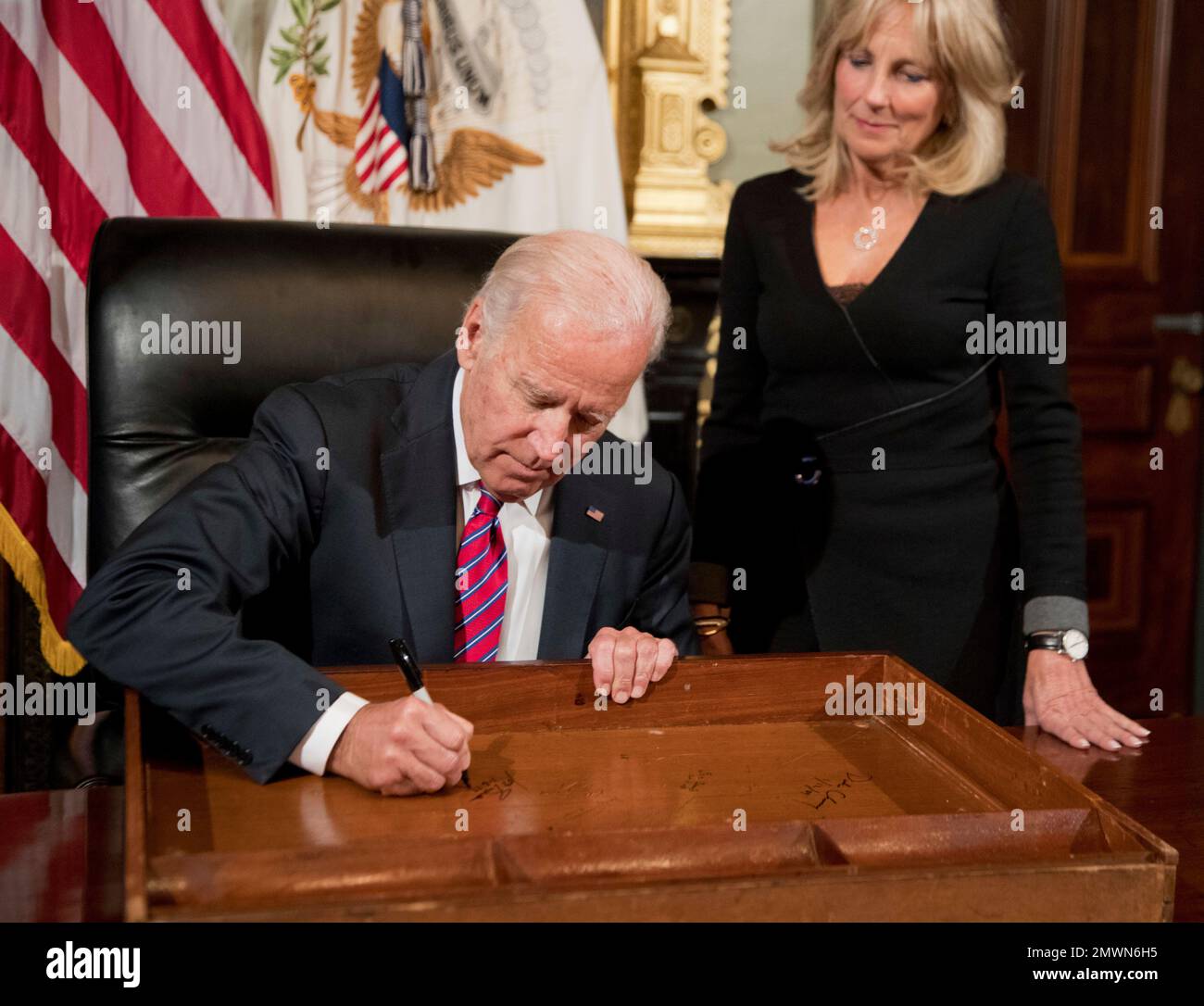 Vice President Joe Biden signs the drawer of the vice president's desk ...