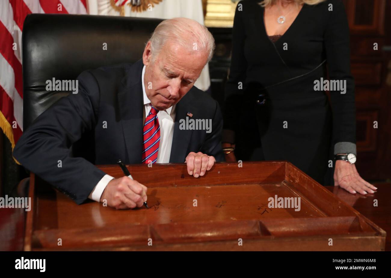 Vice President Joe Biden signs the drawer of the vice president's desk ...