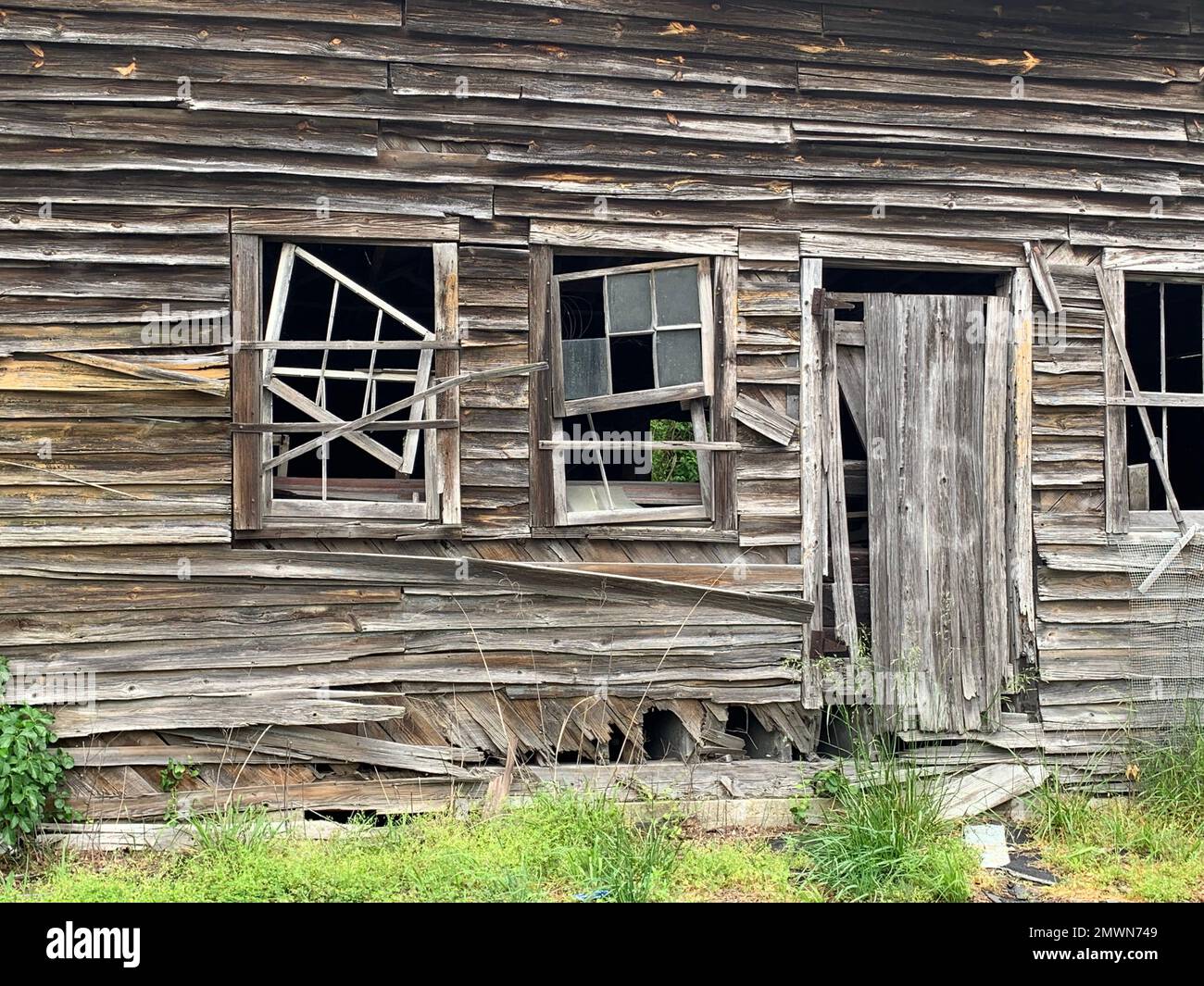 A wooden barn's broken doors and windows in the farm Stock Photo - Alamy
