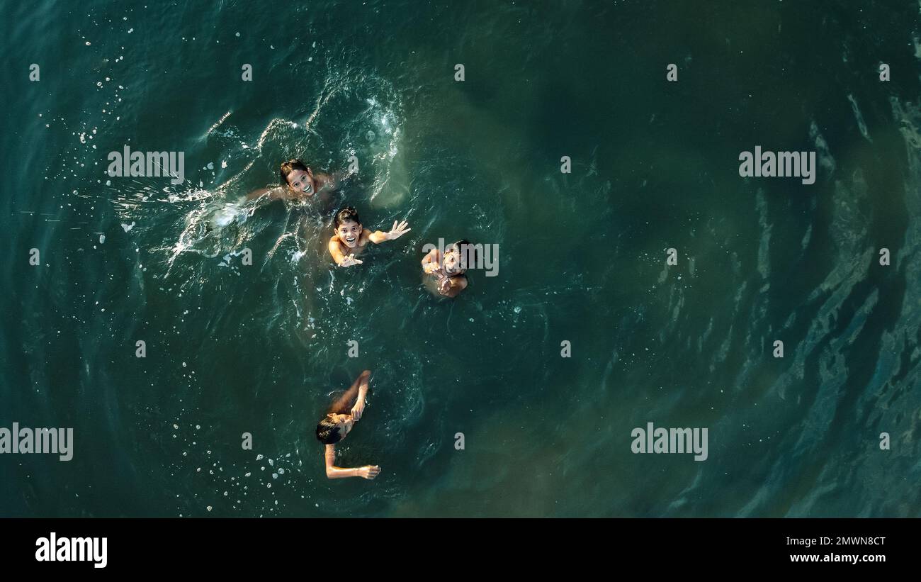 A top view of the group of happy kids playing and having fun in the river in Bangalore, India ...