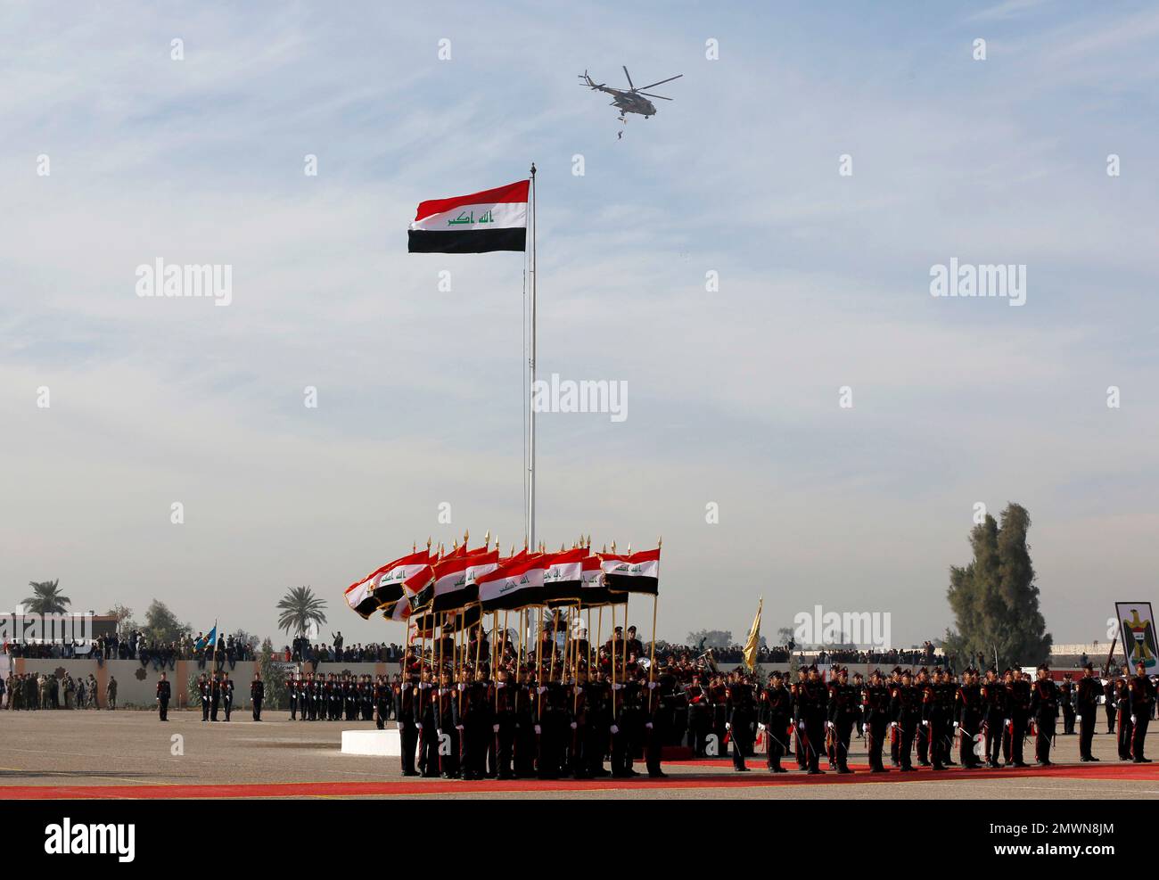 Iraqi Army soldiers march with Iraqi national flags during Iraqi Army ...