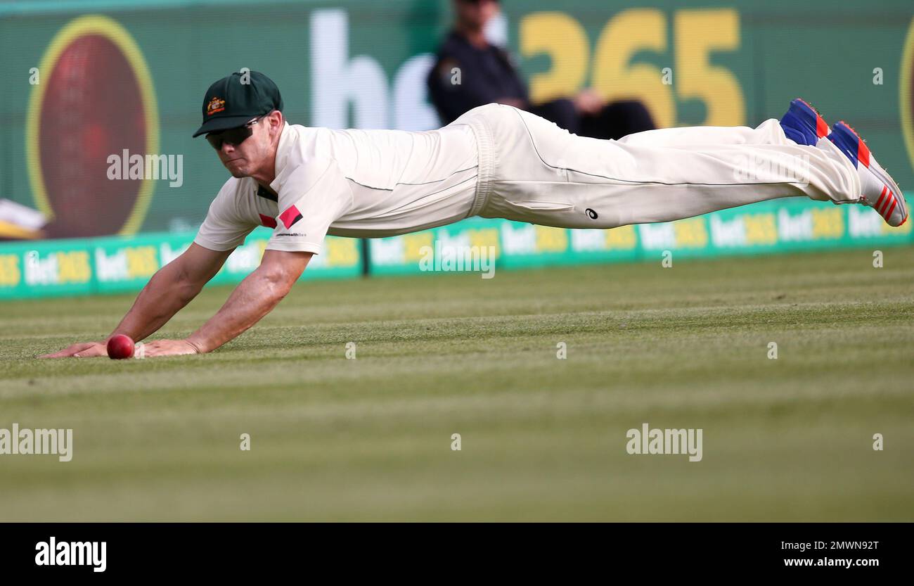 Australia's Hilton Cartwright dives to stop the ball from running to ...