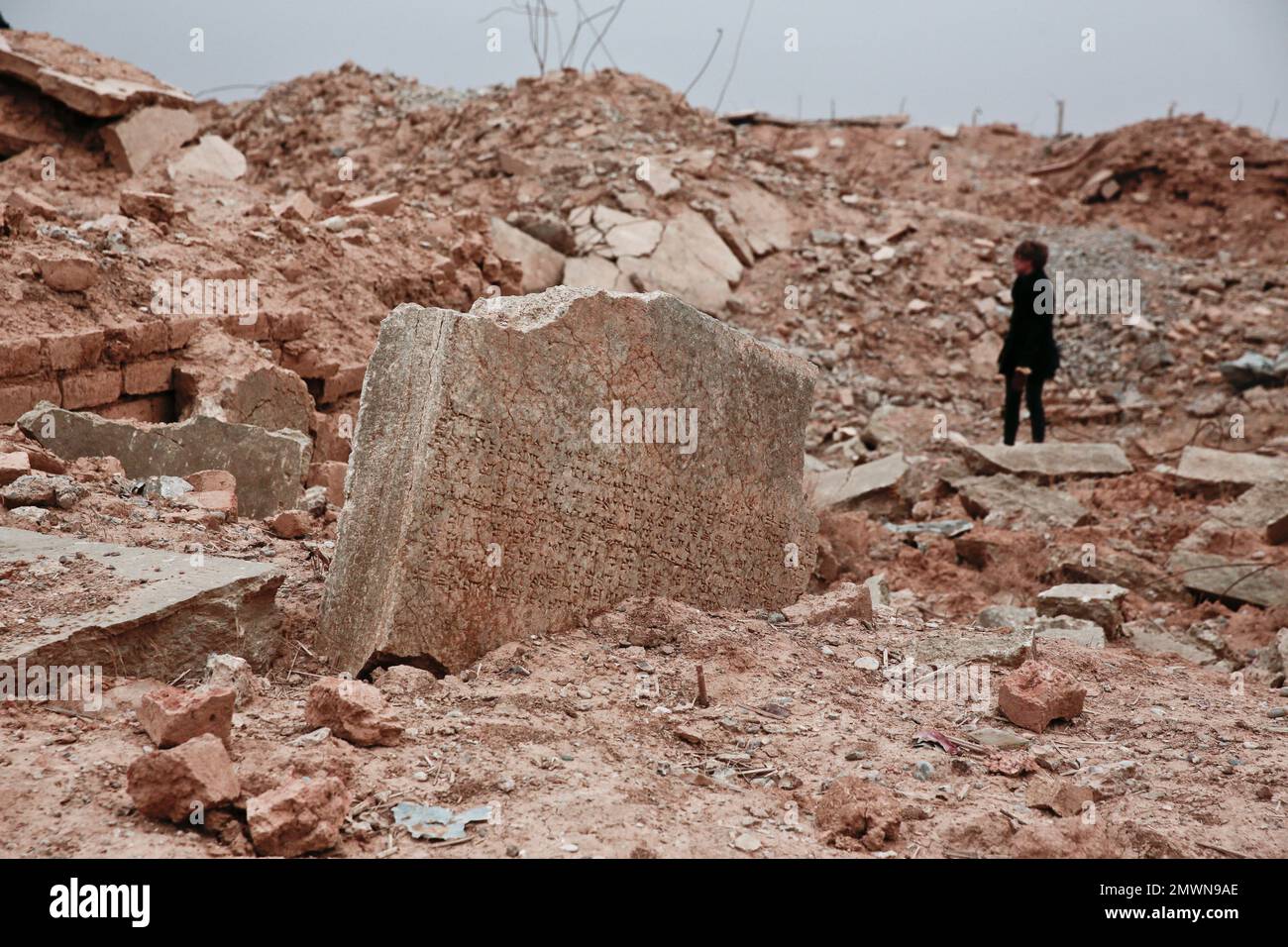 A stone tablet with cuneiform writing is seen in the foreground as ...