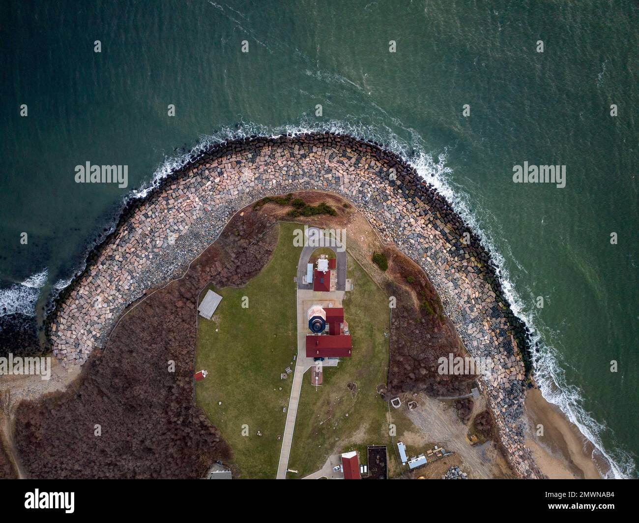 An aerial top view of the Montauk Lighthouse surrounded by the waters ...