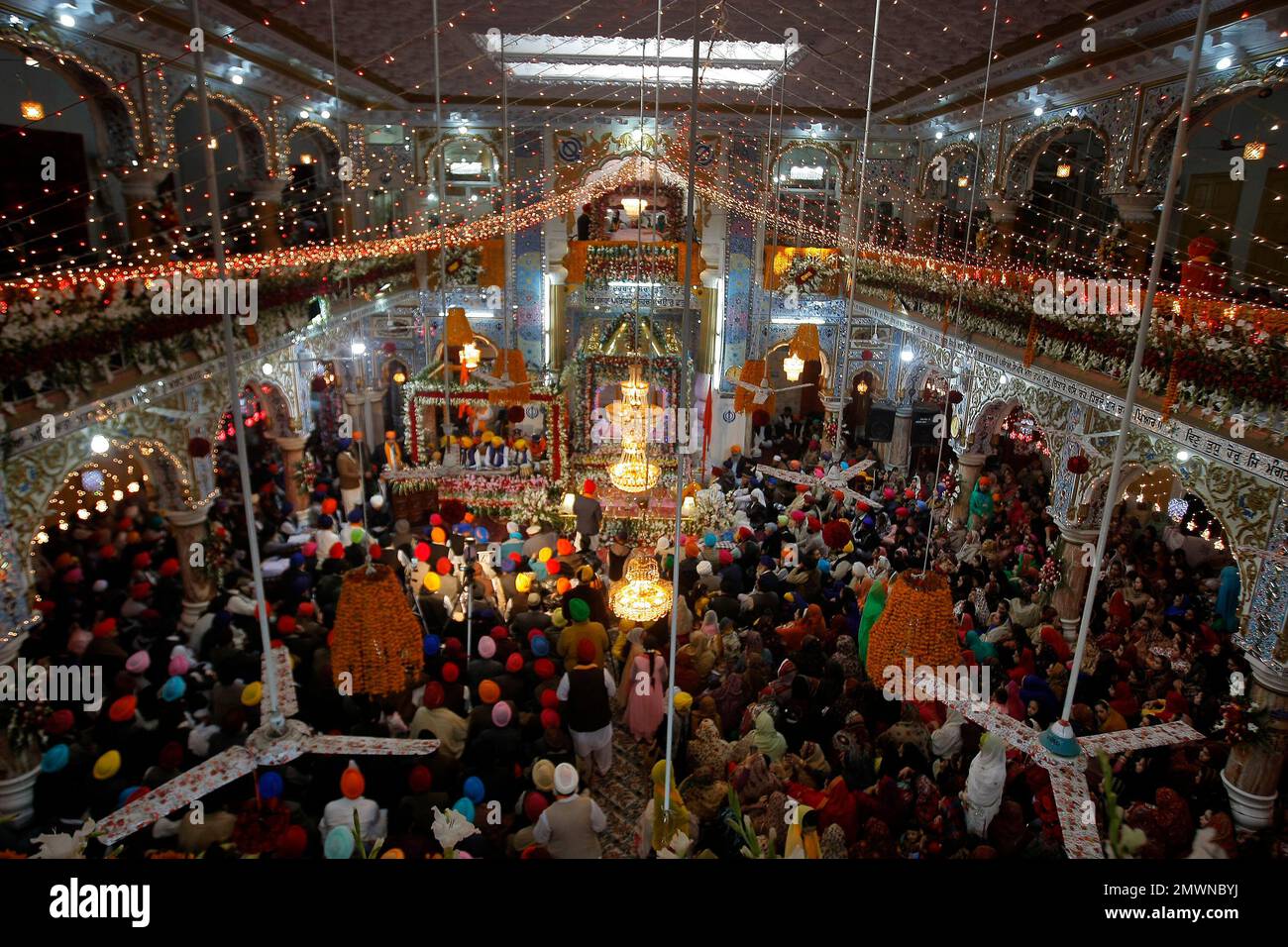 People from the Pakistani Sikh community gather at their temple to ...