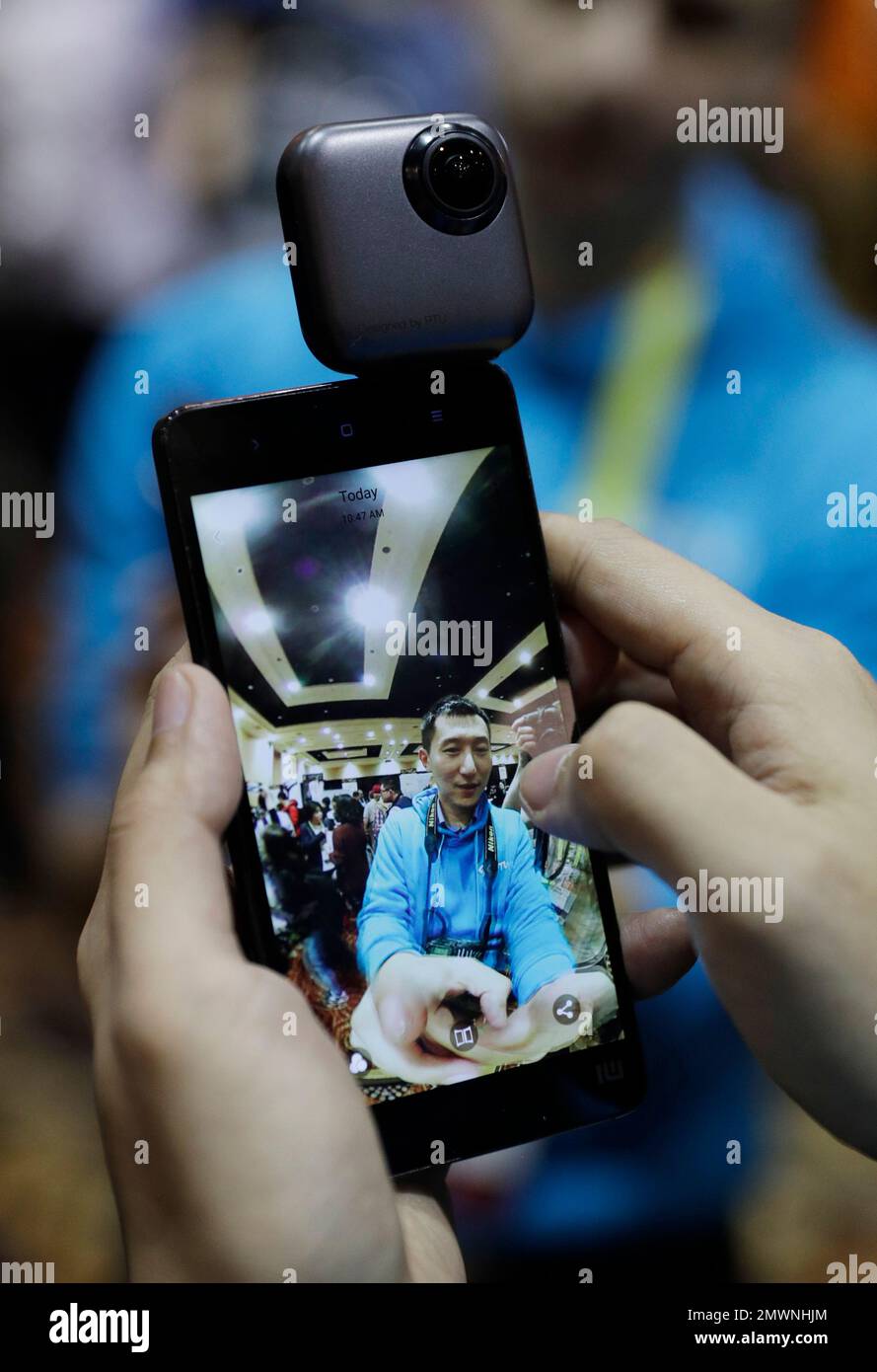 An employee uses a PTU 360 degree spherical camera during CES Unveiled ...