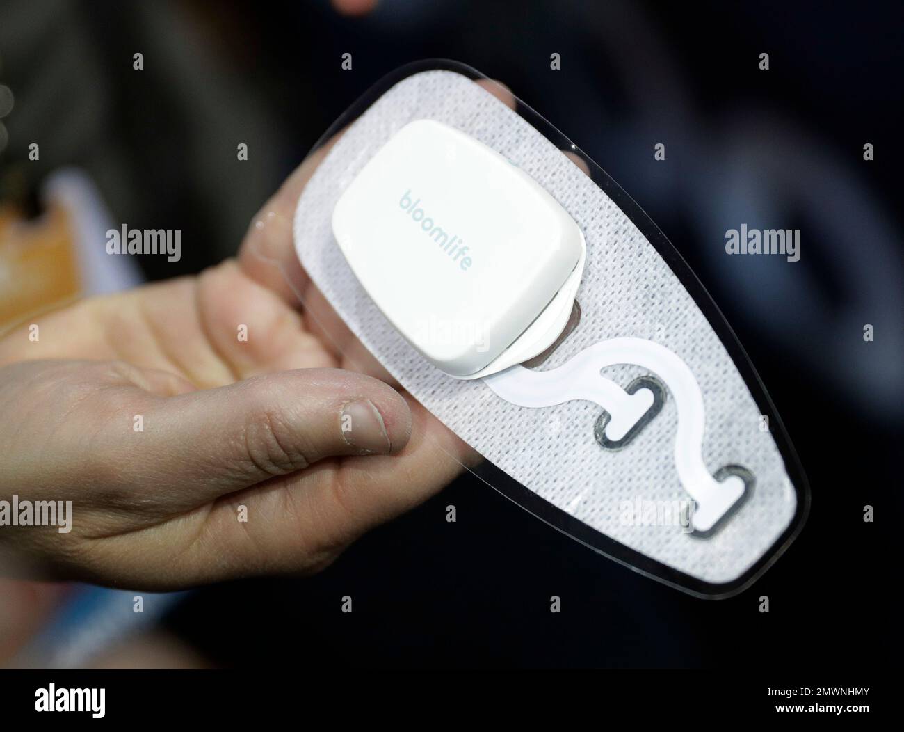 An employee holds up the Bloomlife wearable contraction sensor during ...