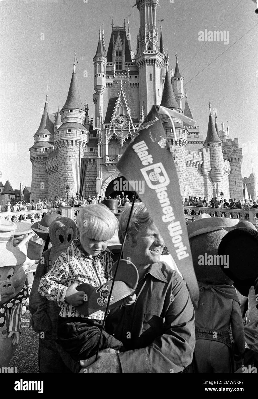 William Windsor Jr. carries his son Lee, 1 1/2, past Cinderella's ...