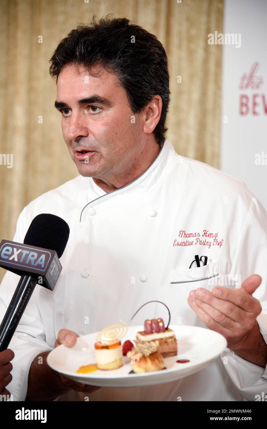 Executive pastry chef Thomas Henzi holds his Dessert Trio plate as he ...