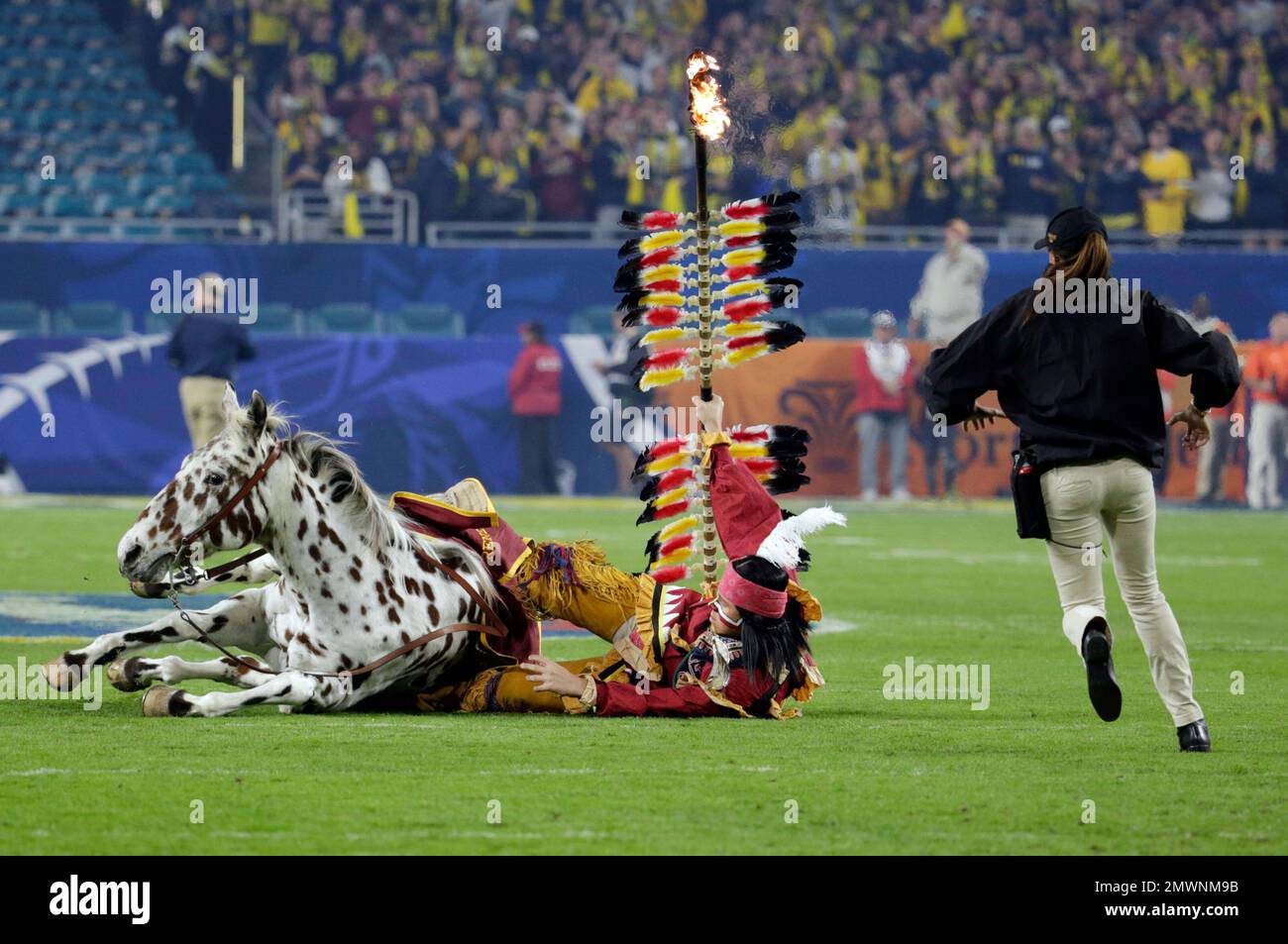 The Florida State mascot Osceola falls from the horse during a pre-game ...