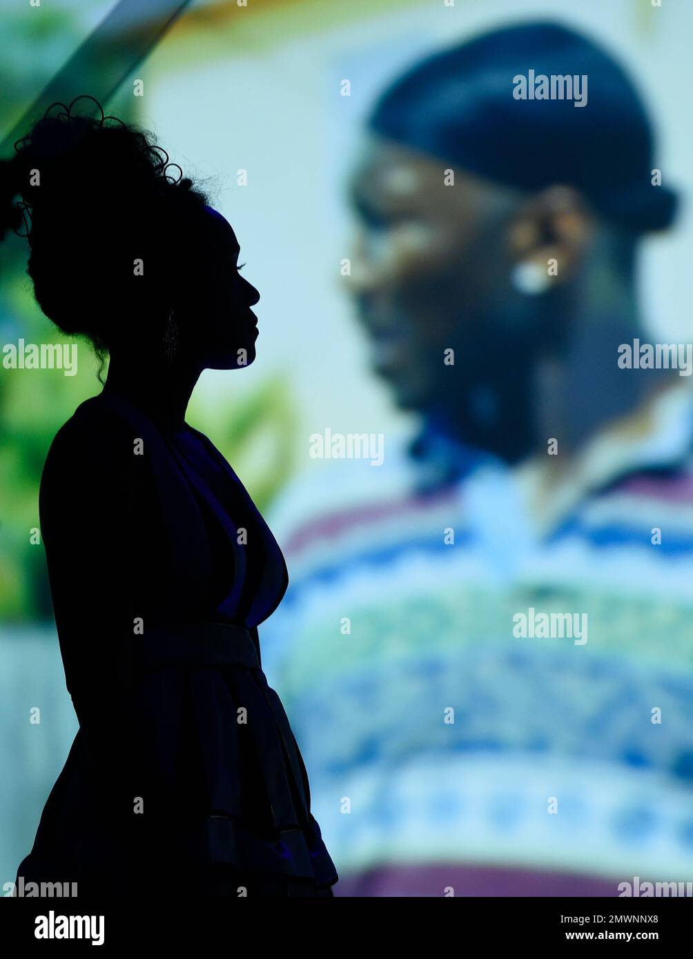 Janelle Monae looks on as an image of Mahershala Ali appear on screen ...