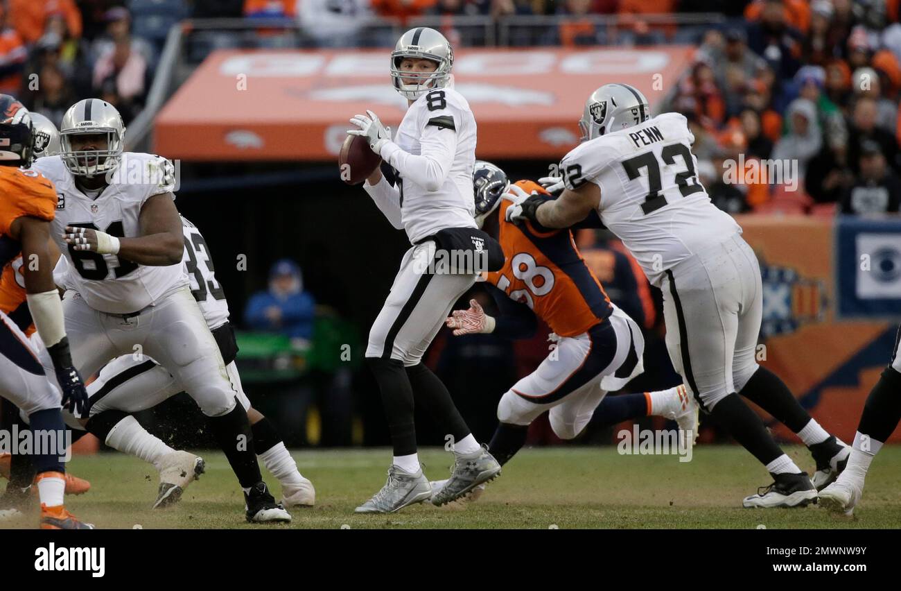 Oakland Raiders quarterback Connor Cook passes as tackle Donald Penn ...