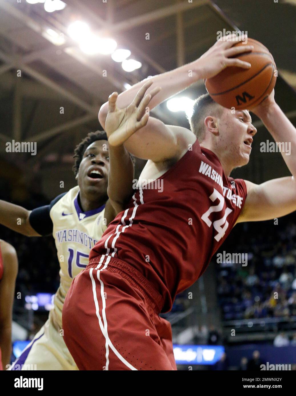 Washington State's Josh Hawkinson (24) grabs a rebound in front of ...