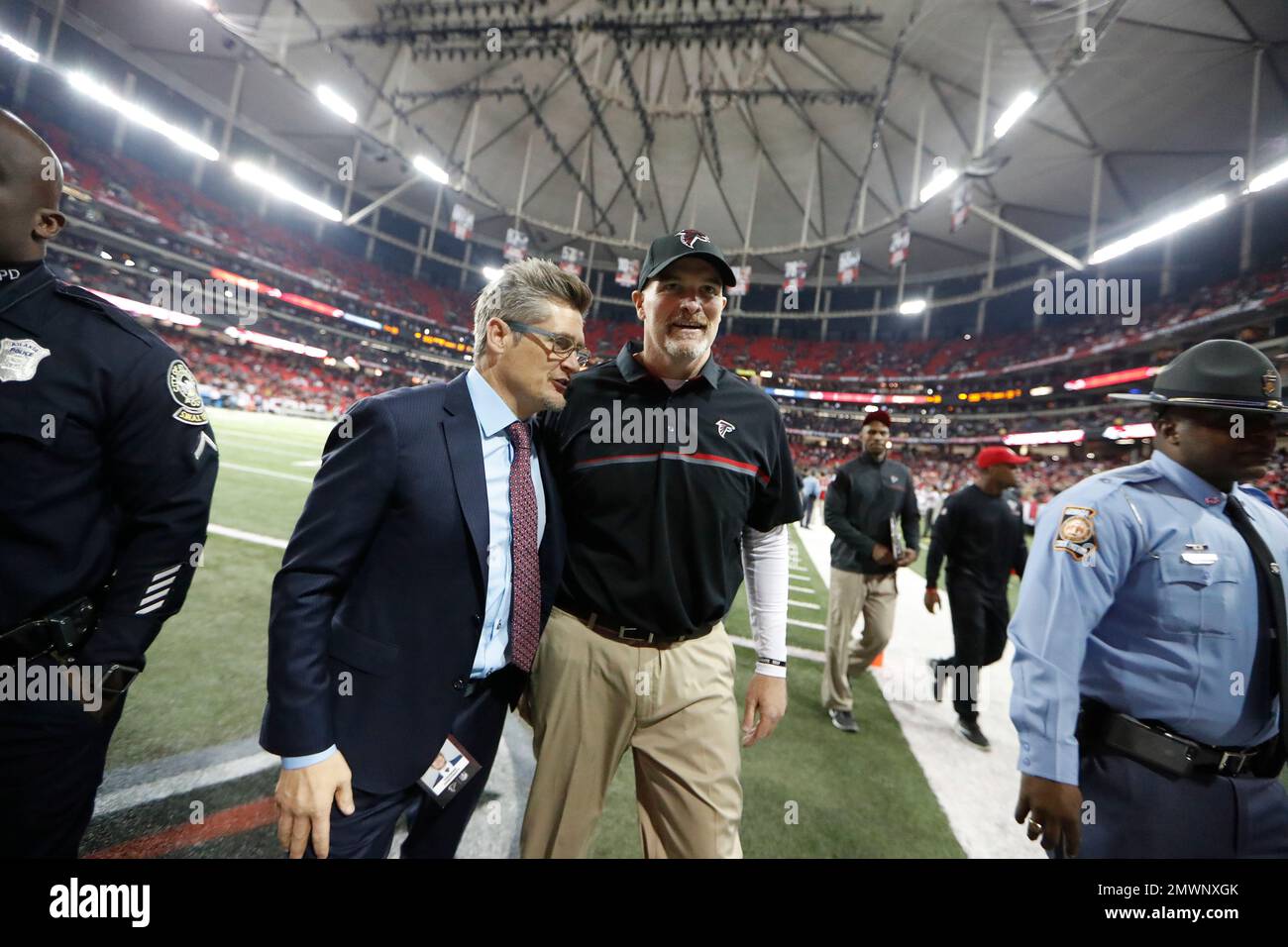 Atlanta Falcons head coach Dan Quinn runs off the field with Atlanta ...