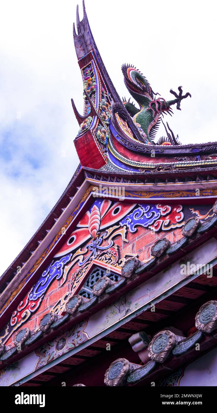 A vertical shot of a dragon sculptures on a temple roof Stock Photo - Alamy