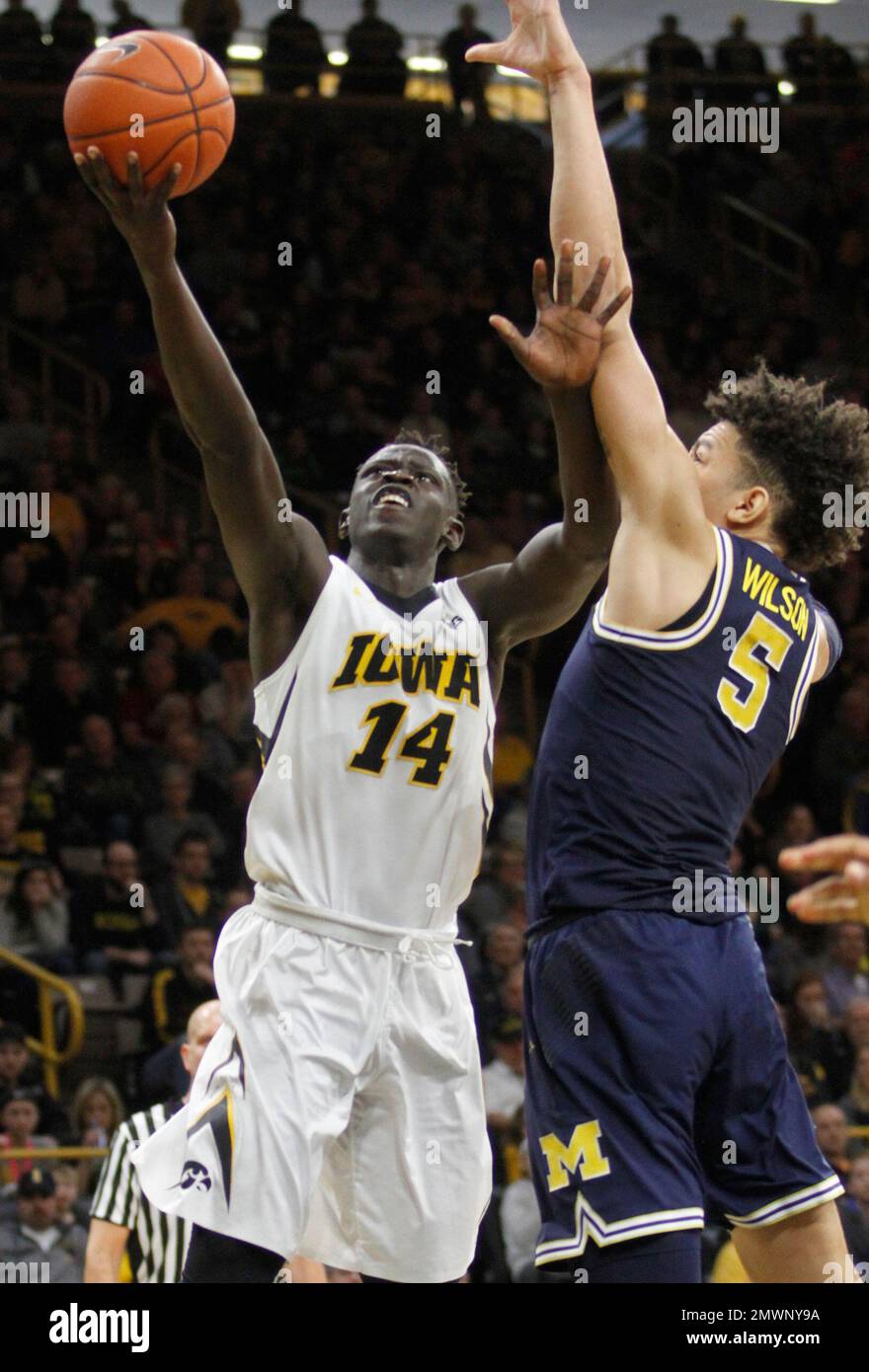 Iowa's Peter Jok (14) goes to the basket against Michigan's D.J. Wilson ...