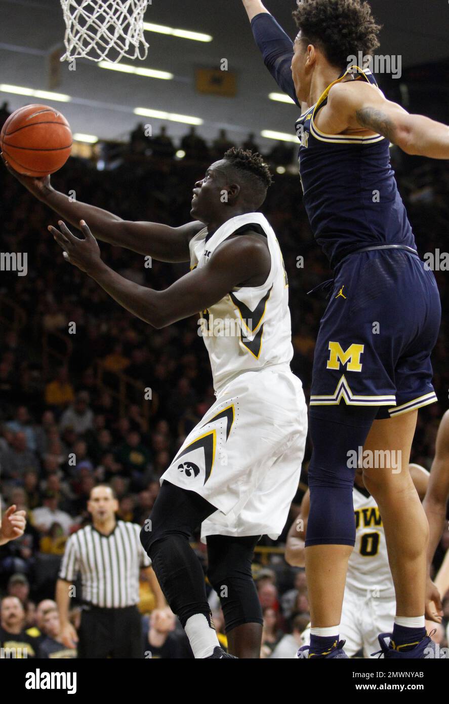 Iowa's Peter Jok (14) goes to the basket against Michigan's D.J. Wilson ...