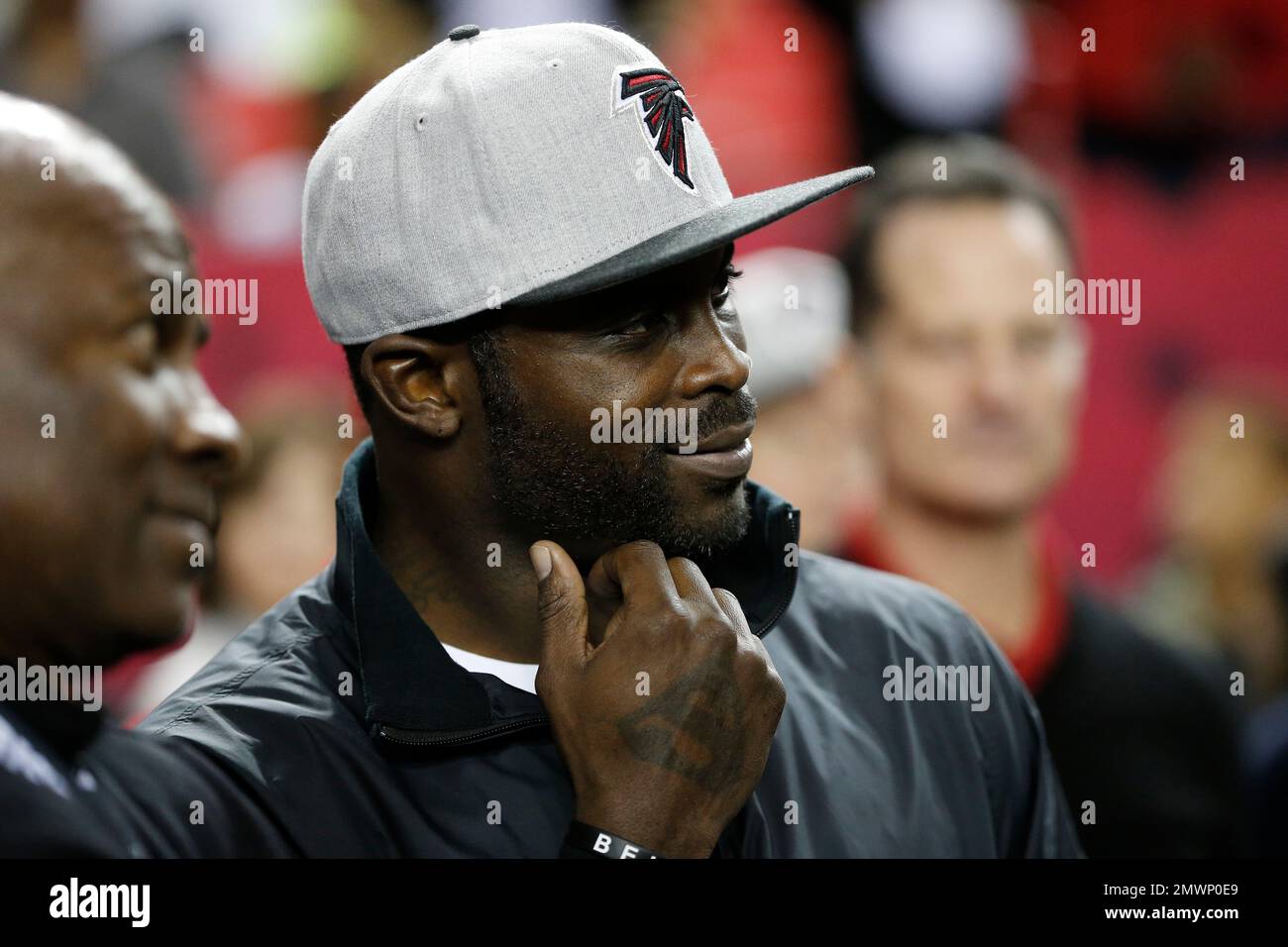 Former Atlanta Falcons quarterback Michael Vick stands on the sidelines ...